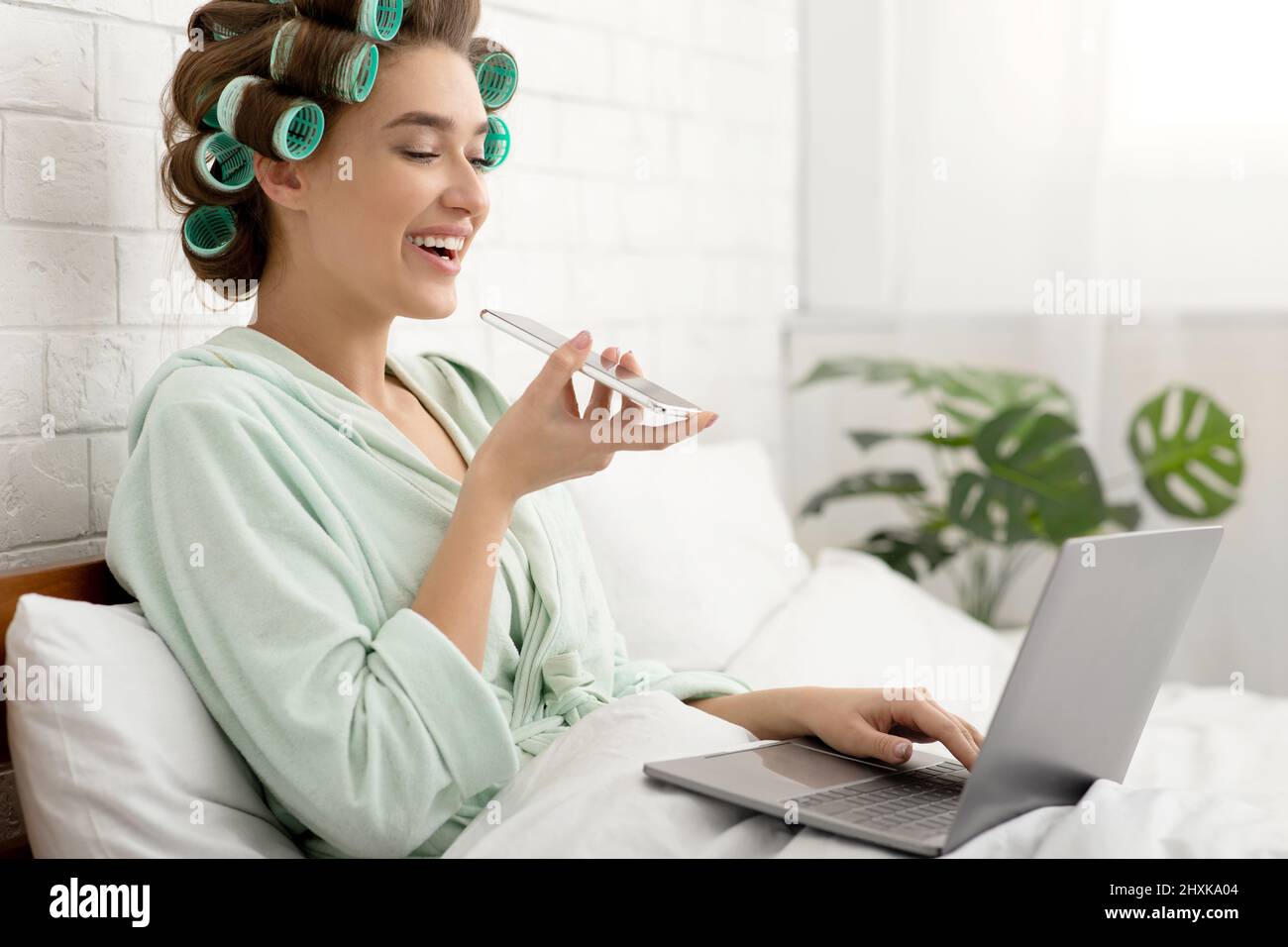 Woman Using Voice Search App On Cellphone And Laptop Indoor Stock Photo ...