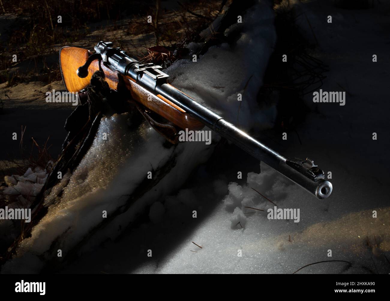 Surplus military bolt action rifle sporterized for hunting on a snowy ...