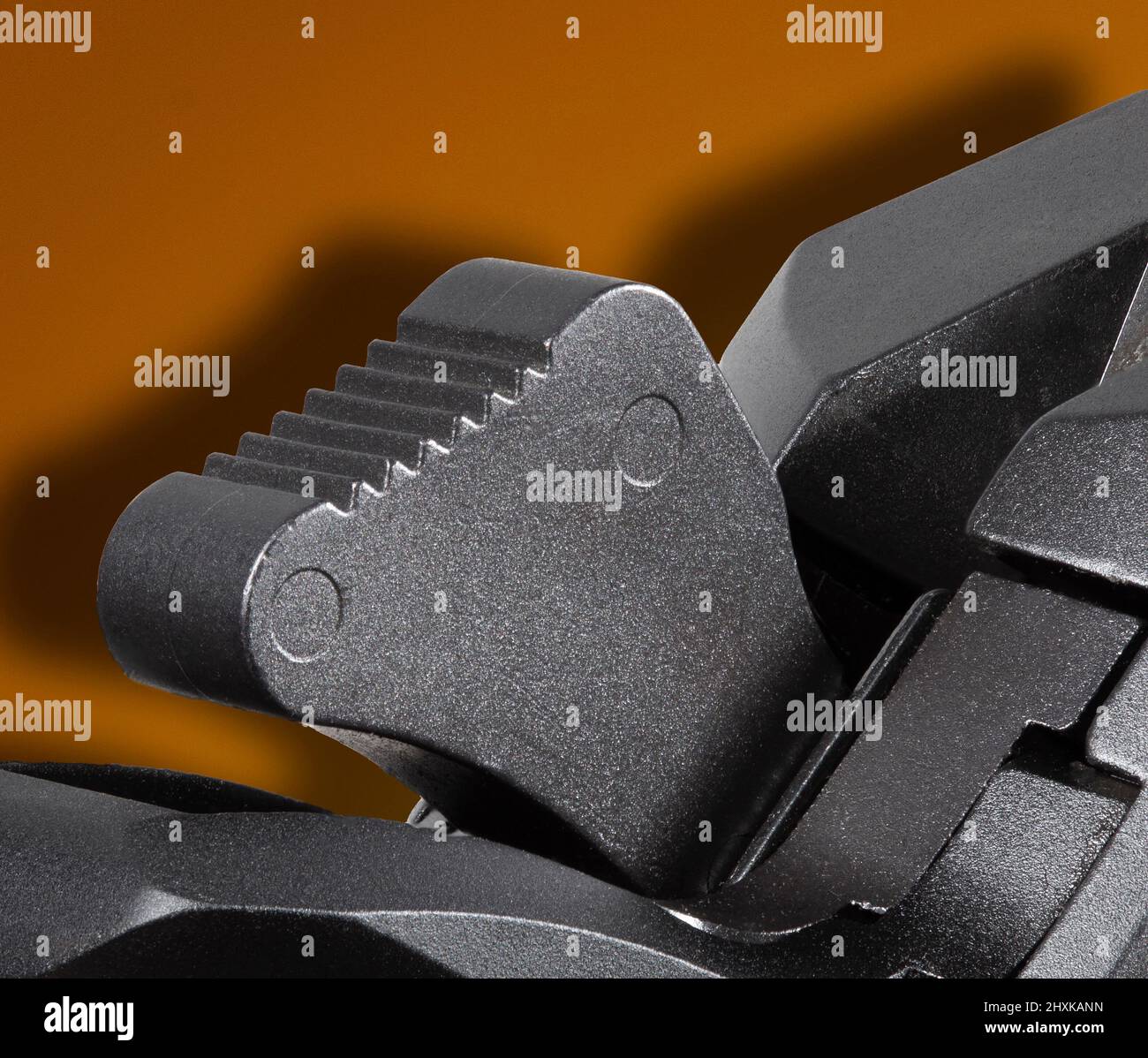 Semi auto handgun hammer on an orange background with shadow Stock ...