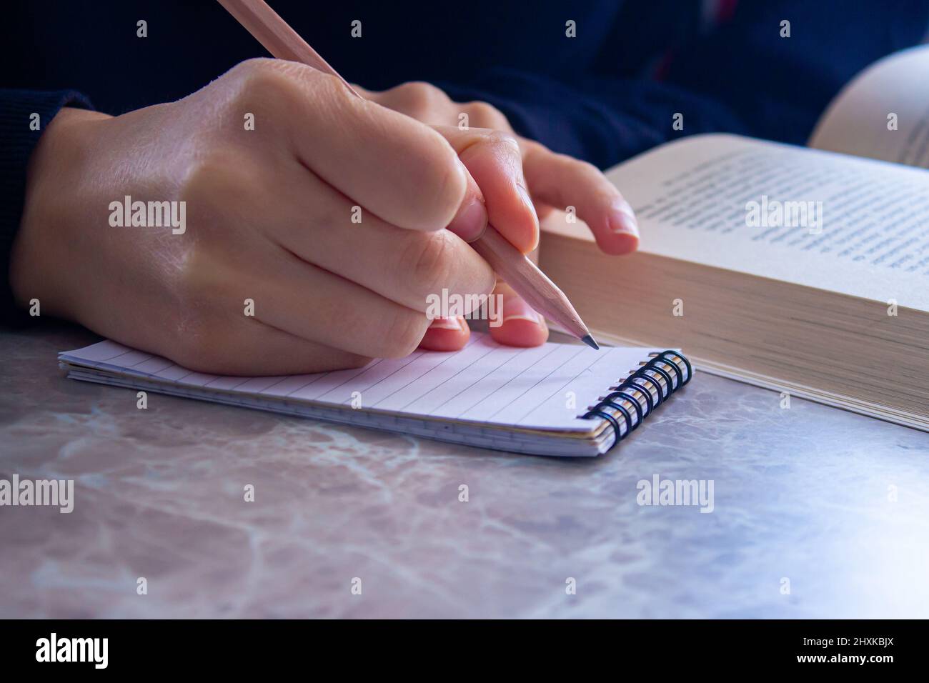 Closeup photo of woman hand taking notes on notebook page Stock Photo ...