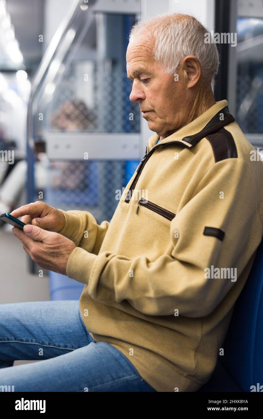 Mature man tapping phone screen hi-res stock photography and images - Alamy