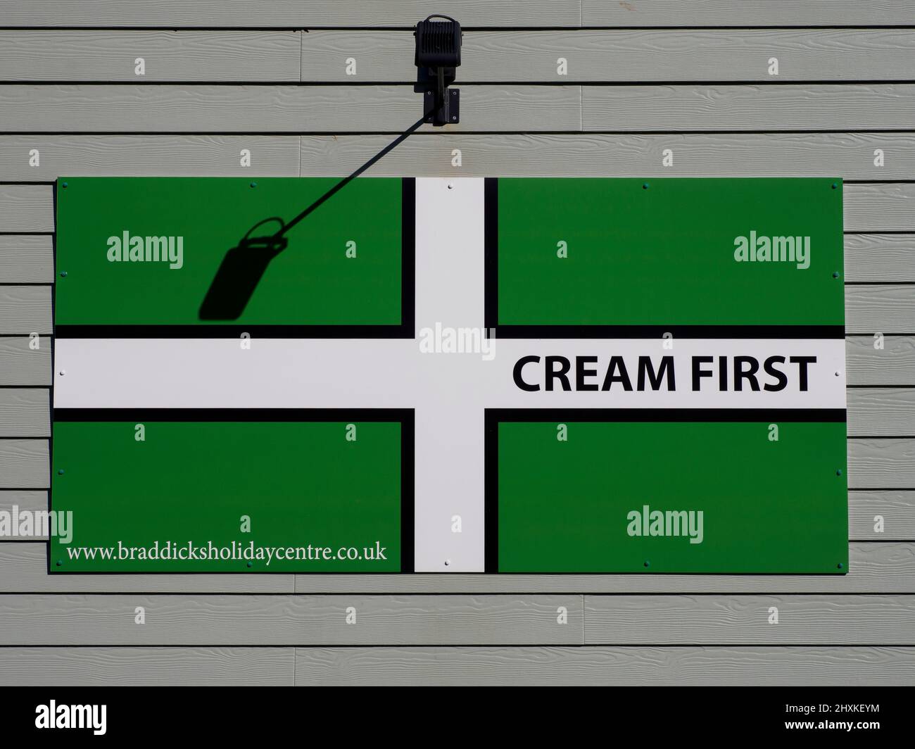 Metal Devon flag on a wall at a holiday park with a dig at the Cornish ...