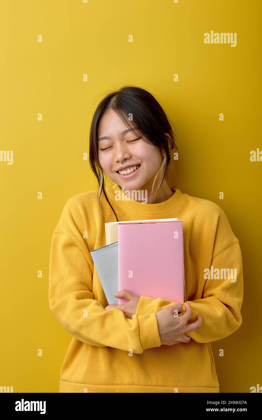 Portrait young happy asian woman hugging books reading education ...