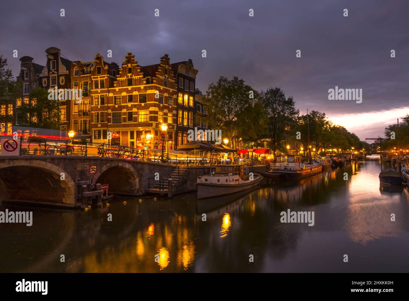 Netherlands. Cloudy evening on the canal of Amsterdam. Houseboats and ...
