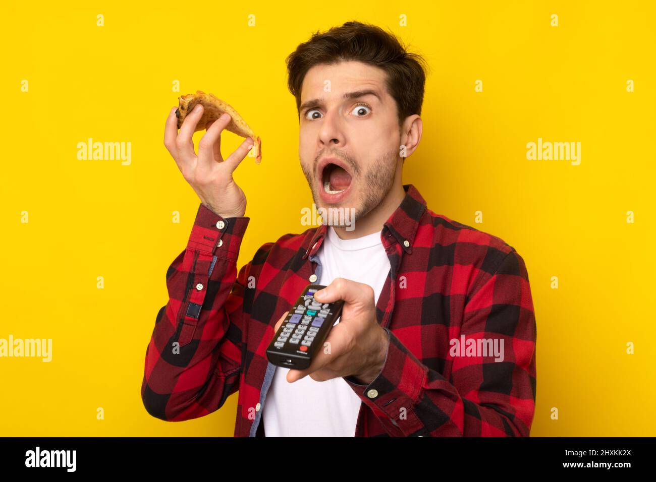Funny Shocked Guy Eating Pizza Holding Remote Control Watching Tv Stock ...
