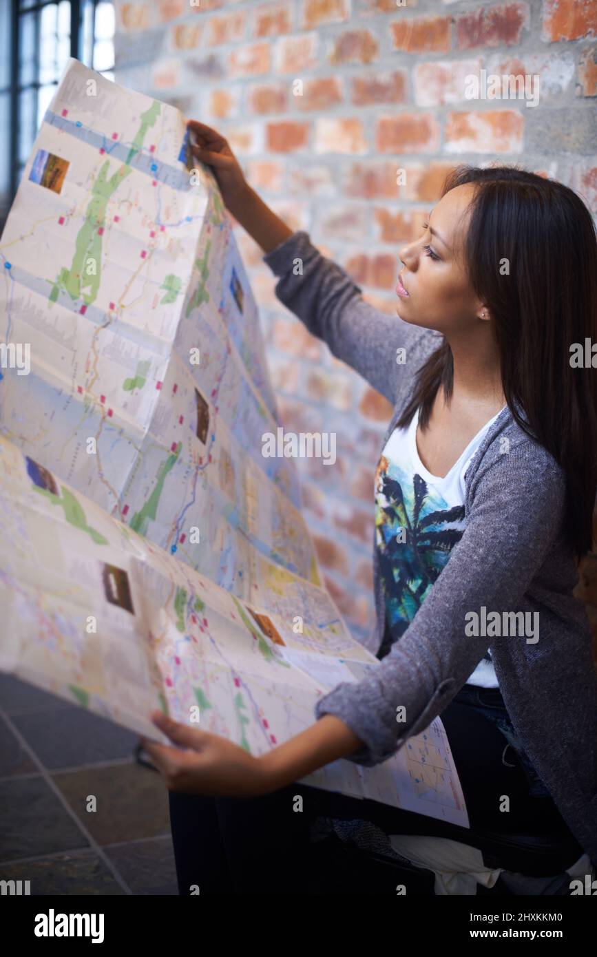 Where should I go next.... A young woman reading a map Stock Photo - Alamy