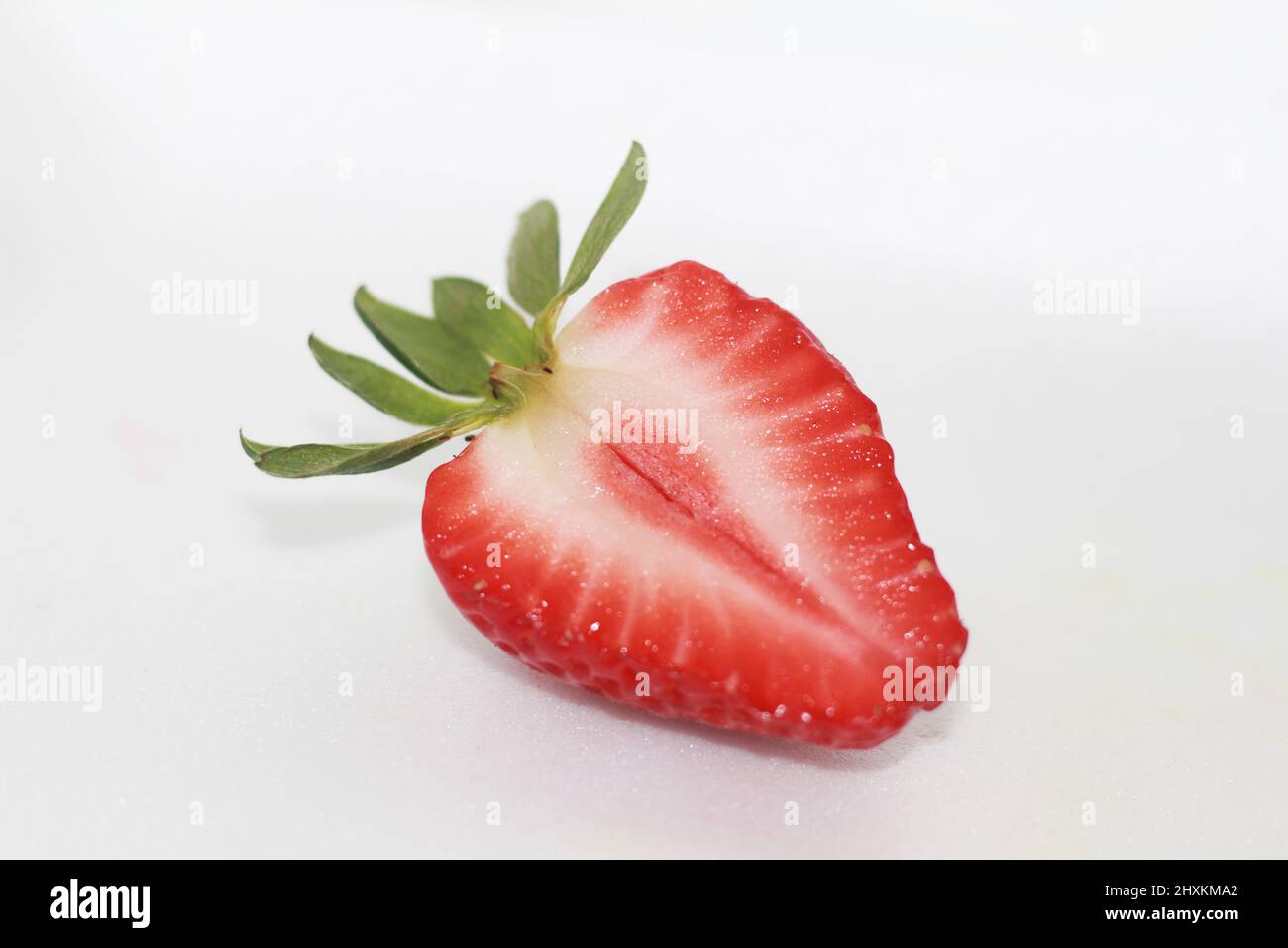 Half slice sharp red strawberry Stock Photo - Alamy