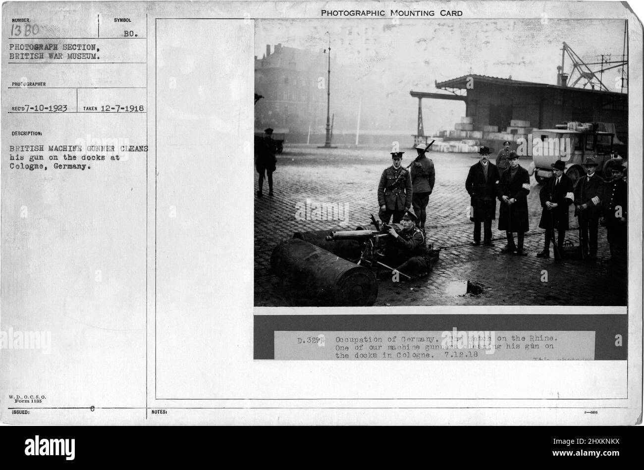 British Machine Gunner cleans his gun on the docks at Cologne, Germany ...