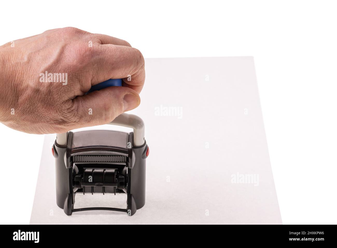 Close up view of hand holding stamp on white paper background Stock ...
