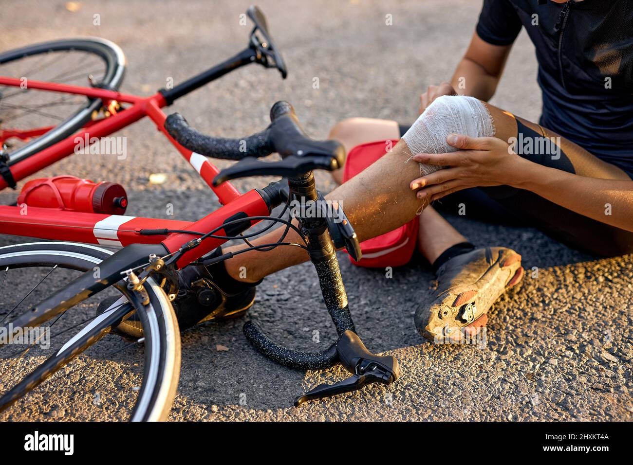 Accident man in sports concept. biker fall from bike and wrapping leg ...