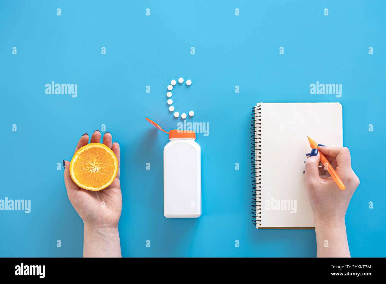Flat lay, pills on blue background, vitamin c concept Stock Photo - Alamy