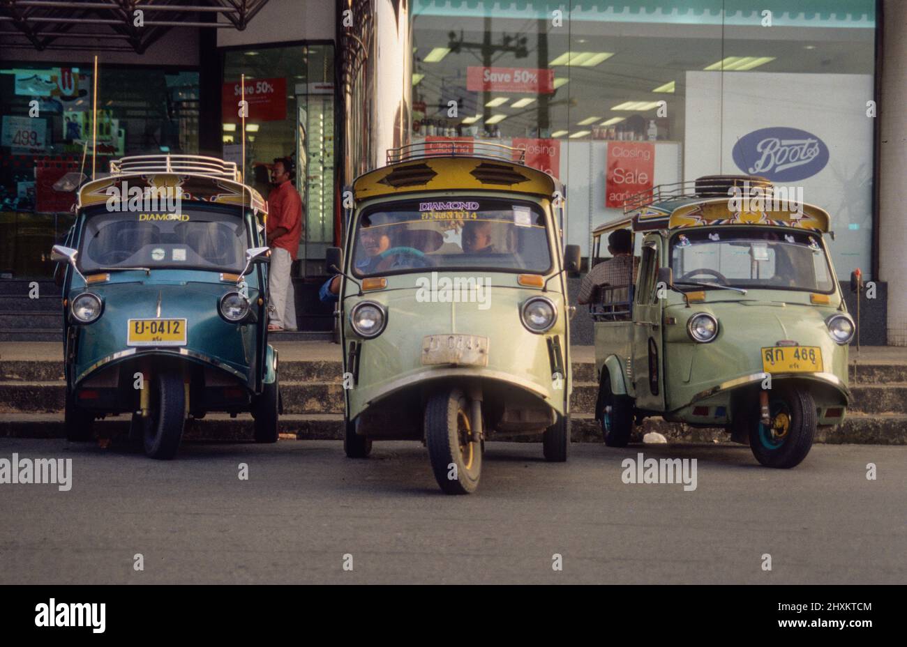 Three tuk-tuk hua kob, the so-called frog-headed tuk-tuks, typical for the provincial capital ...