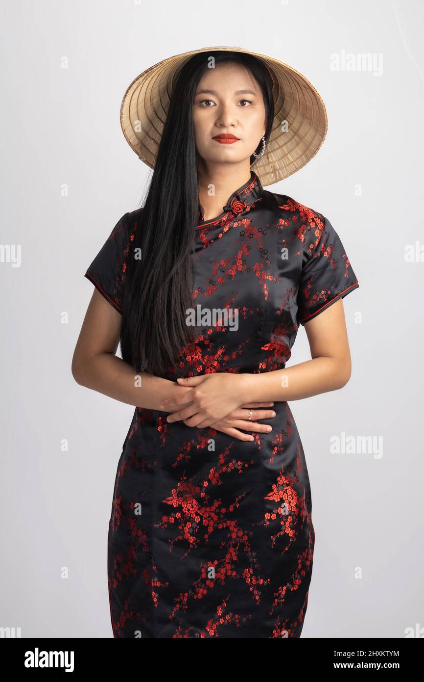 Portrait of Asian woman wearing cone-shaped Asian cane hat and costume ...