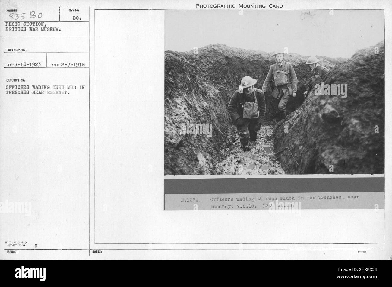 Officers wading through mud in trenches near Esseney. 2-7-1918 ...