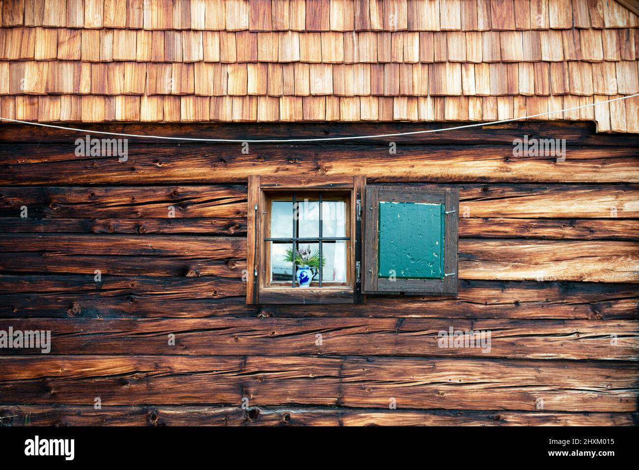 detail of old wooden hut with shingles, window, shutter and wooden ...