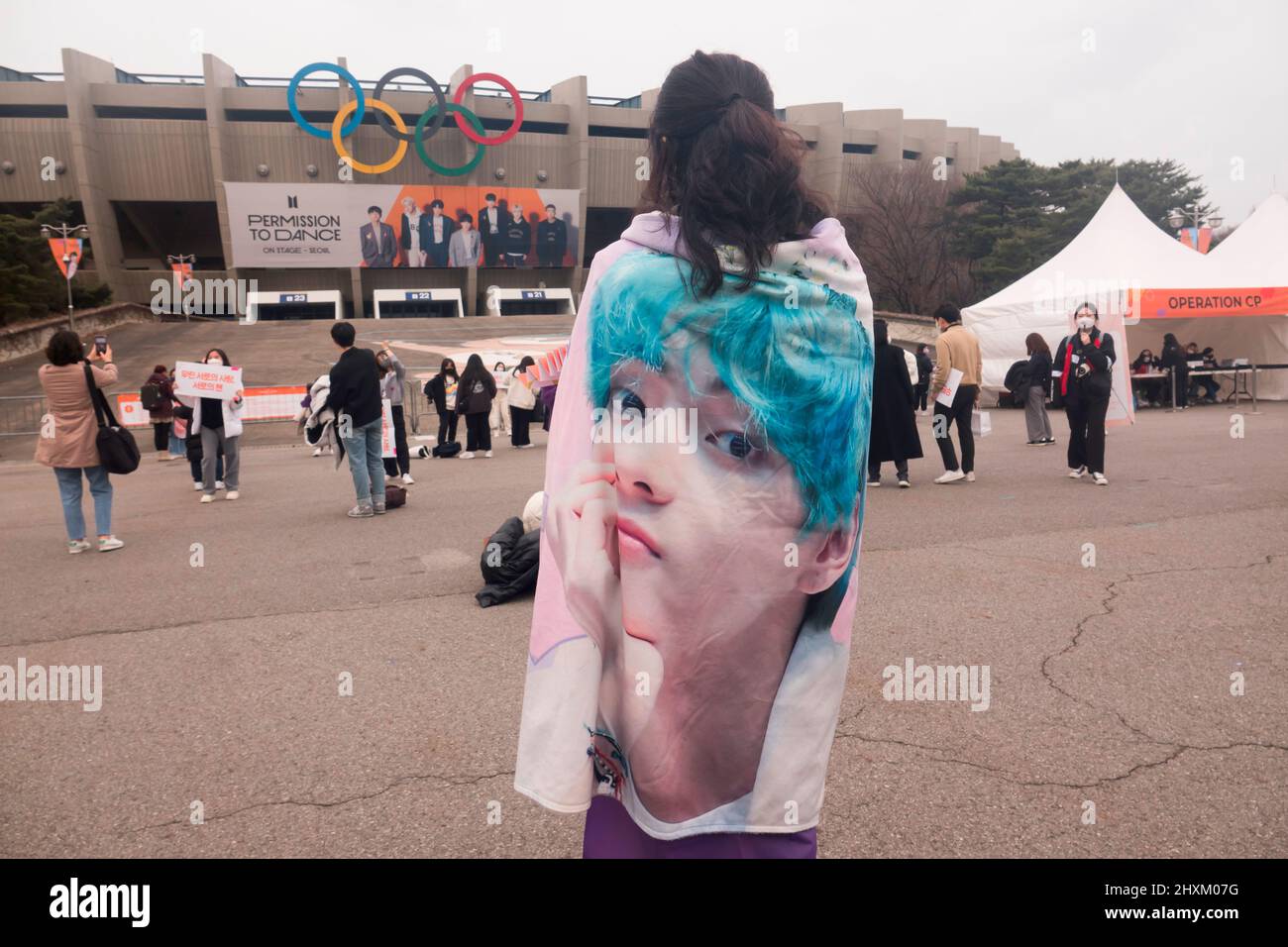 BTS Concert, March 12, 2022 : BTS fans take photos in front of a venue ...