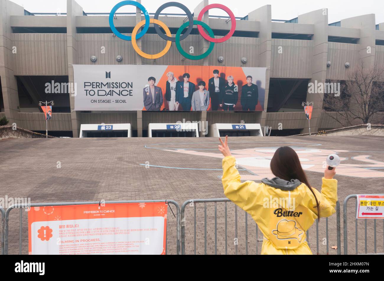 BTS Concert, March 12, 2022 : A BTS fan poses to be photographed by her ...