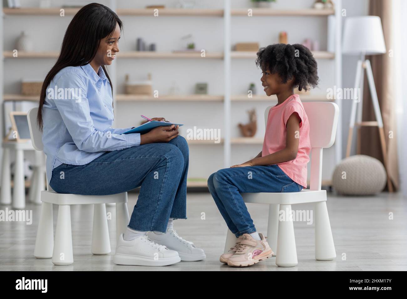 Child psychotherapist having conversation with little girl Stock Photo ... Child psychotherapist having conversation with little girl Stock Photo ...