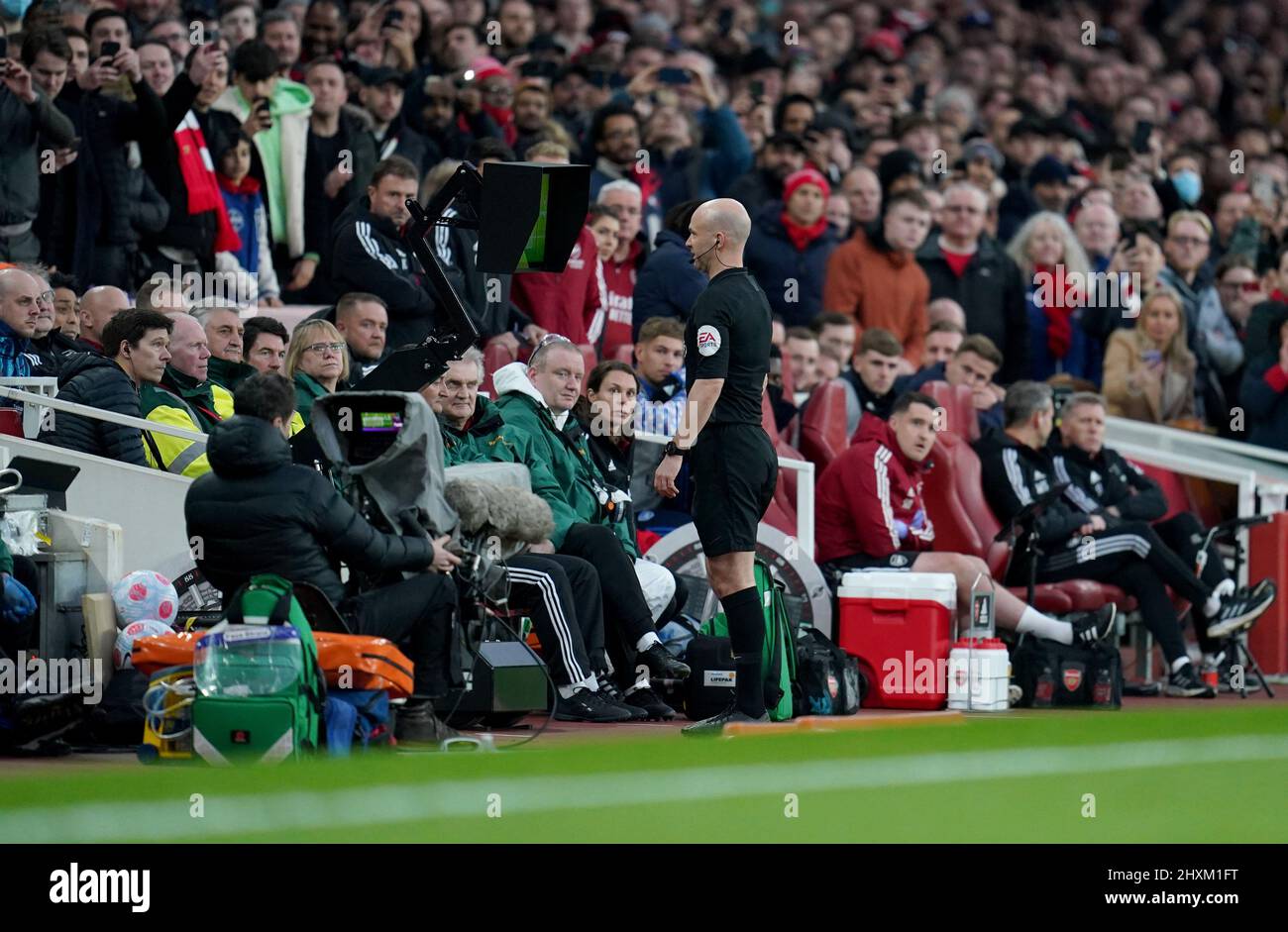 Referee Anthony Taylor checks VAR during the Premier League match at ...