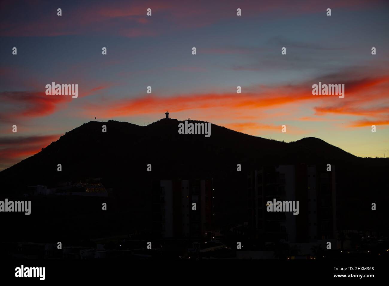 The sunsets behind the lighthouse at the southern most point in Cabo ...