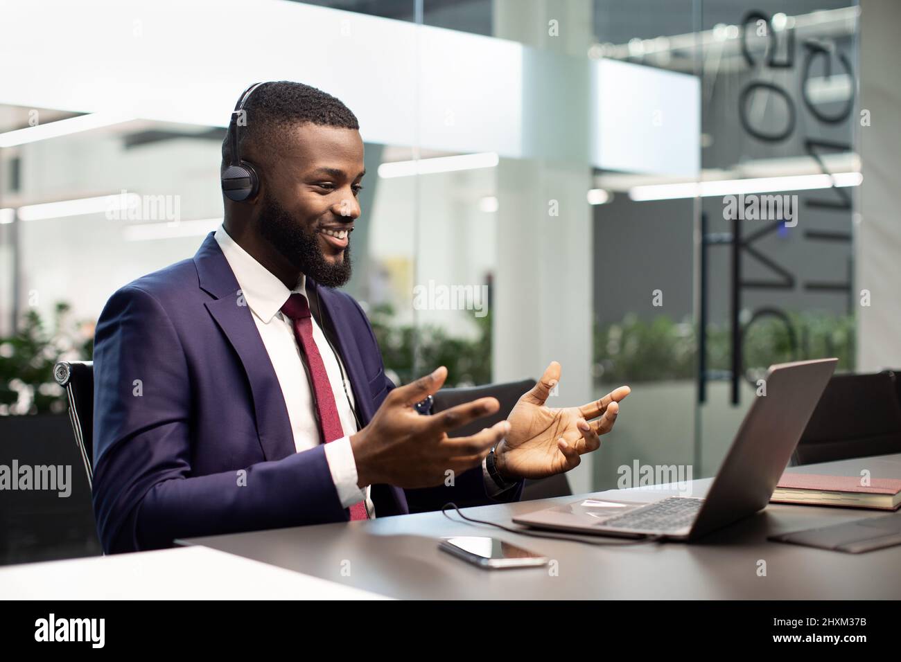 Happy african american CEO having video call at office Stock Photo - Alamy
