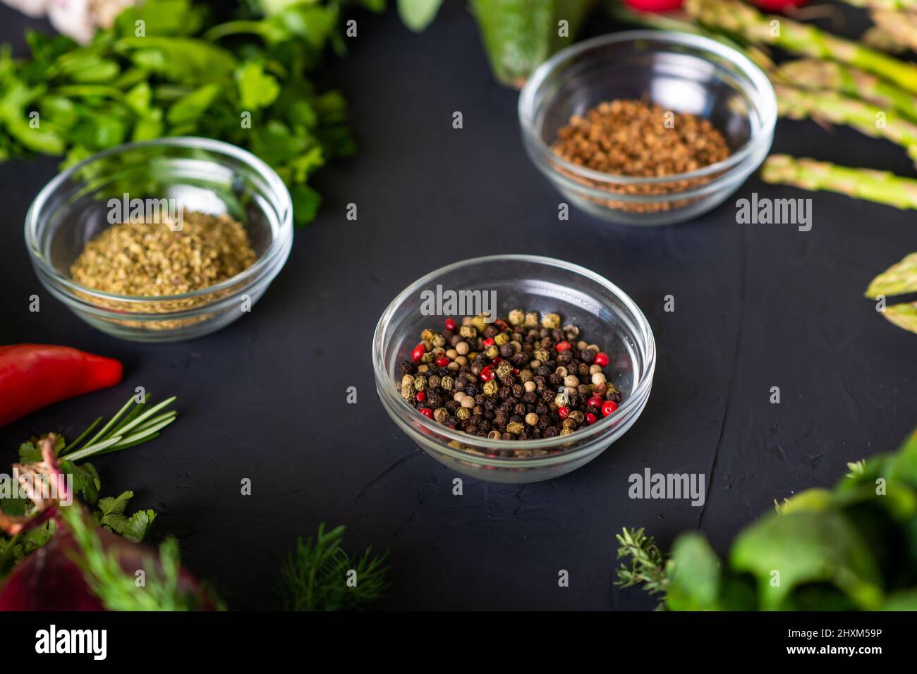 Whole red and black peppers. Dark background. Various vegetables and ...