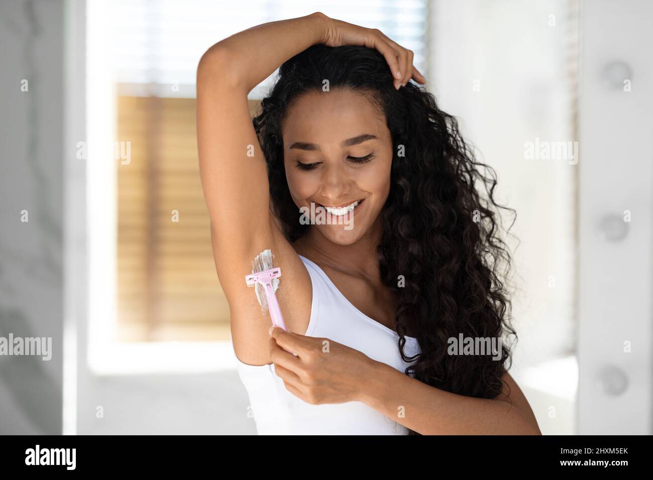 Young woman shaving armpit hi-res stock photography and images - Alamy