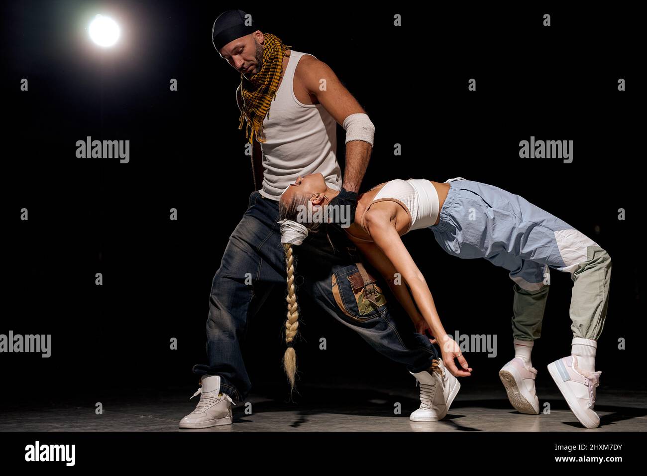 Modern. Active young caucasian couple dancing hip-hop in stylish ...