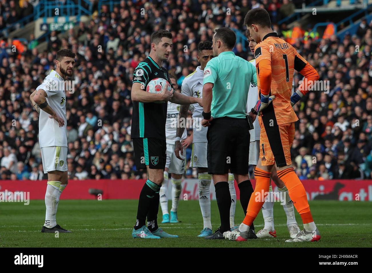 Referee Stuart Attwell speaks with Kenny McLean #23 of Norwich City as ...