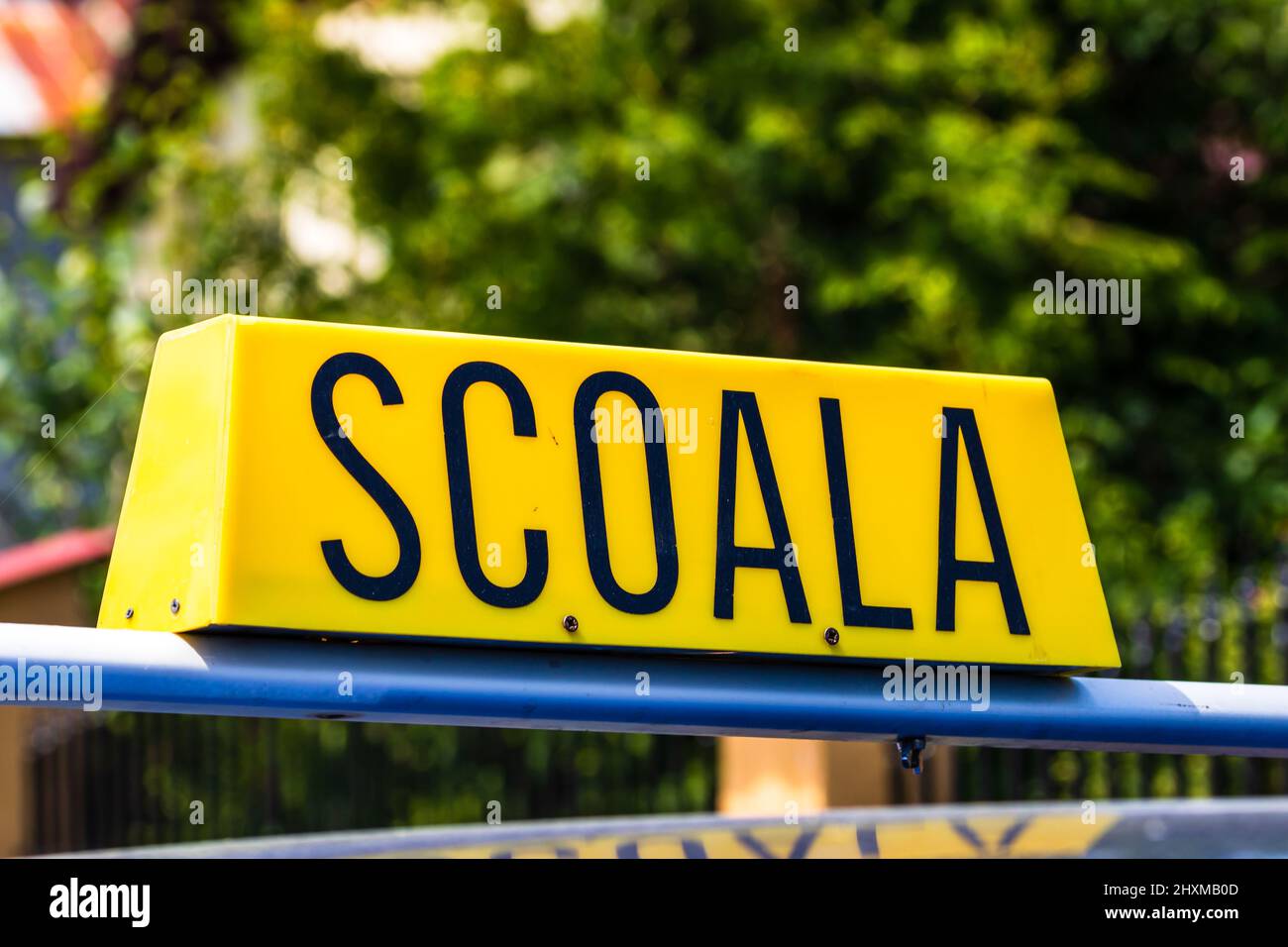 Driving school sign placed on top of car Stock Photo - Alamy