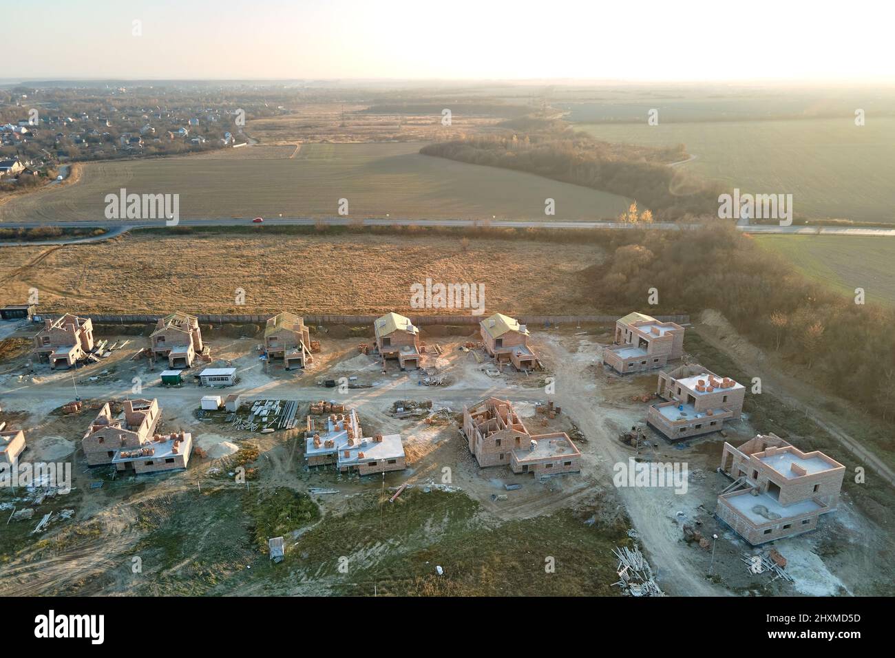 Aerial view of new homes with brick framework walls under construction ...