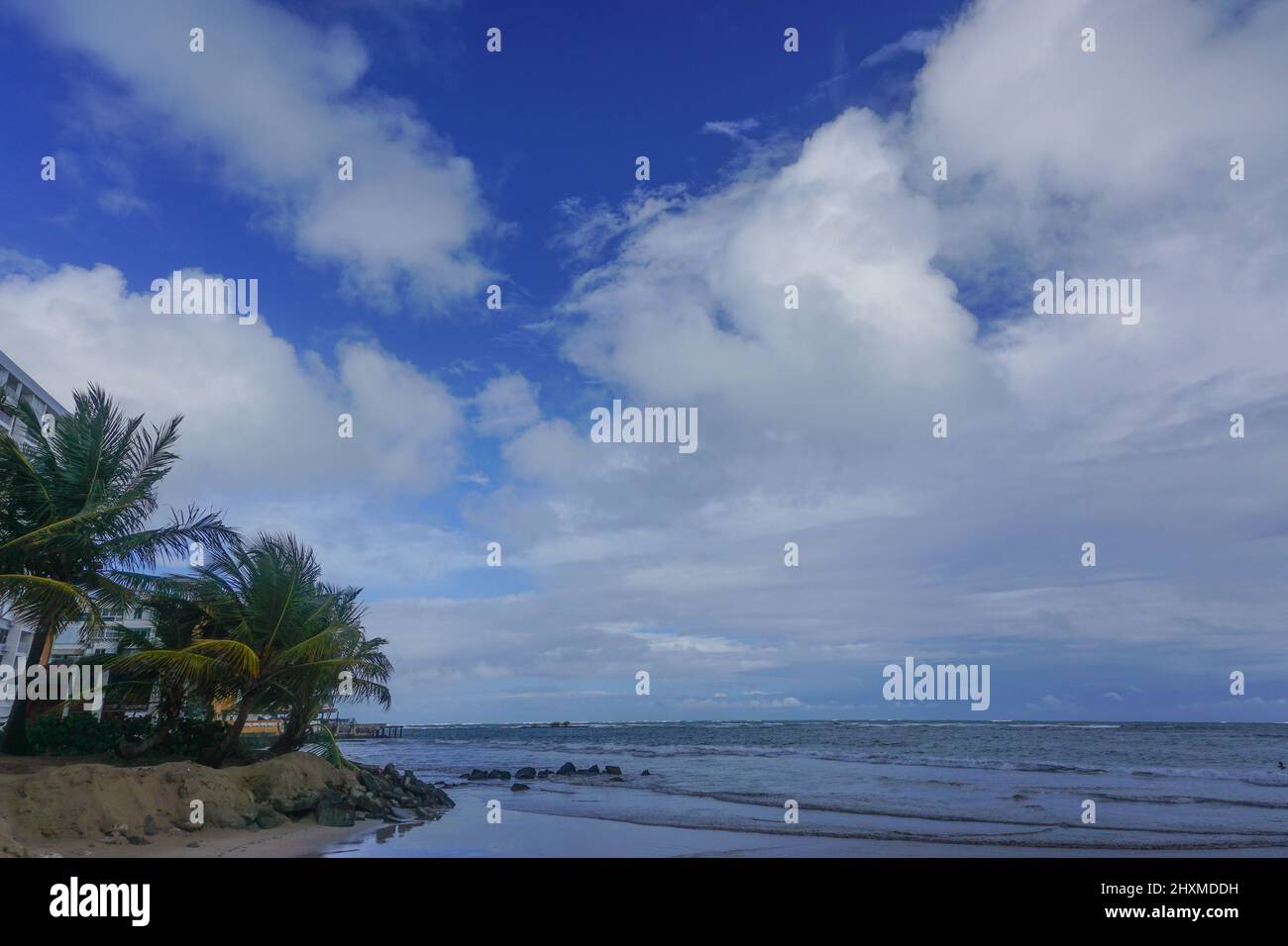 Isla Verde Beach, Puerto Rico, USA: Palm trees and hotels on a beach in ...