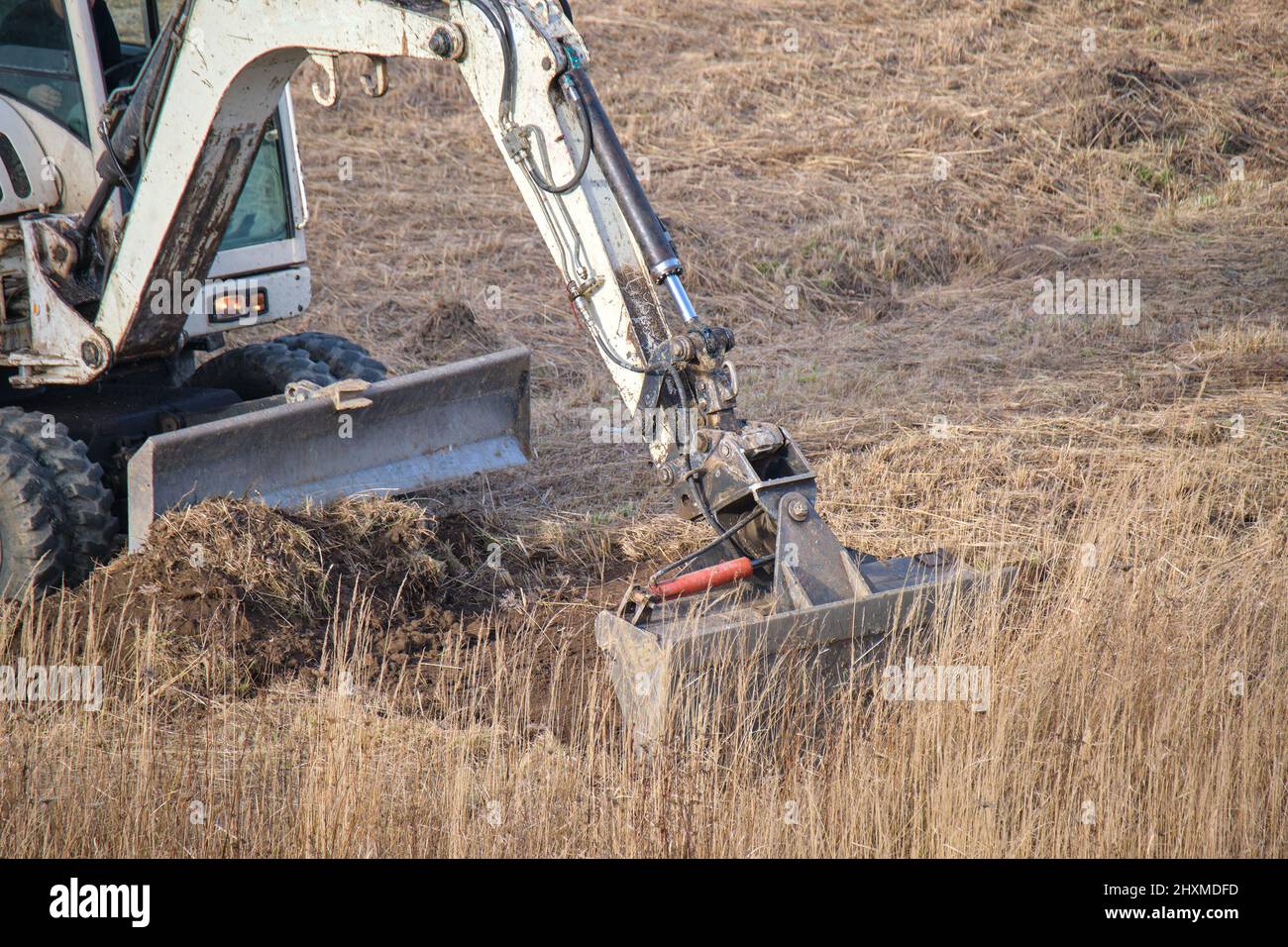 Earth moving tractor preparing place for future house foundation ...