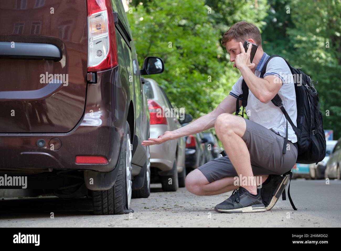 Driver calling road service for assistance having vehicle trouble with ...