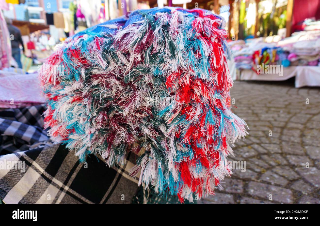 Colorful fringed or tasseled fabric pieces in woman producer bazaar ...