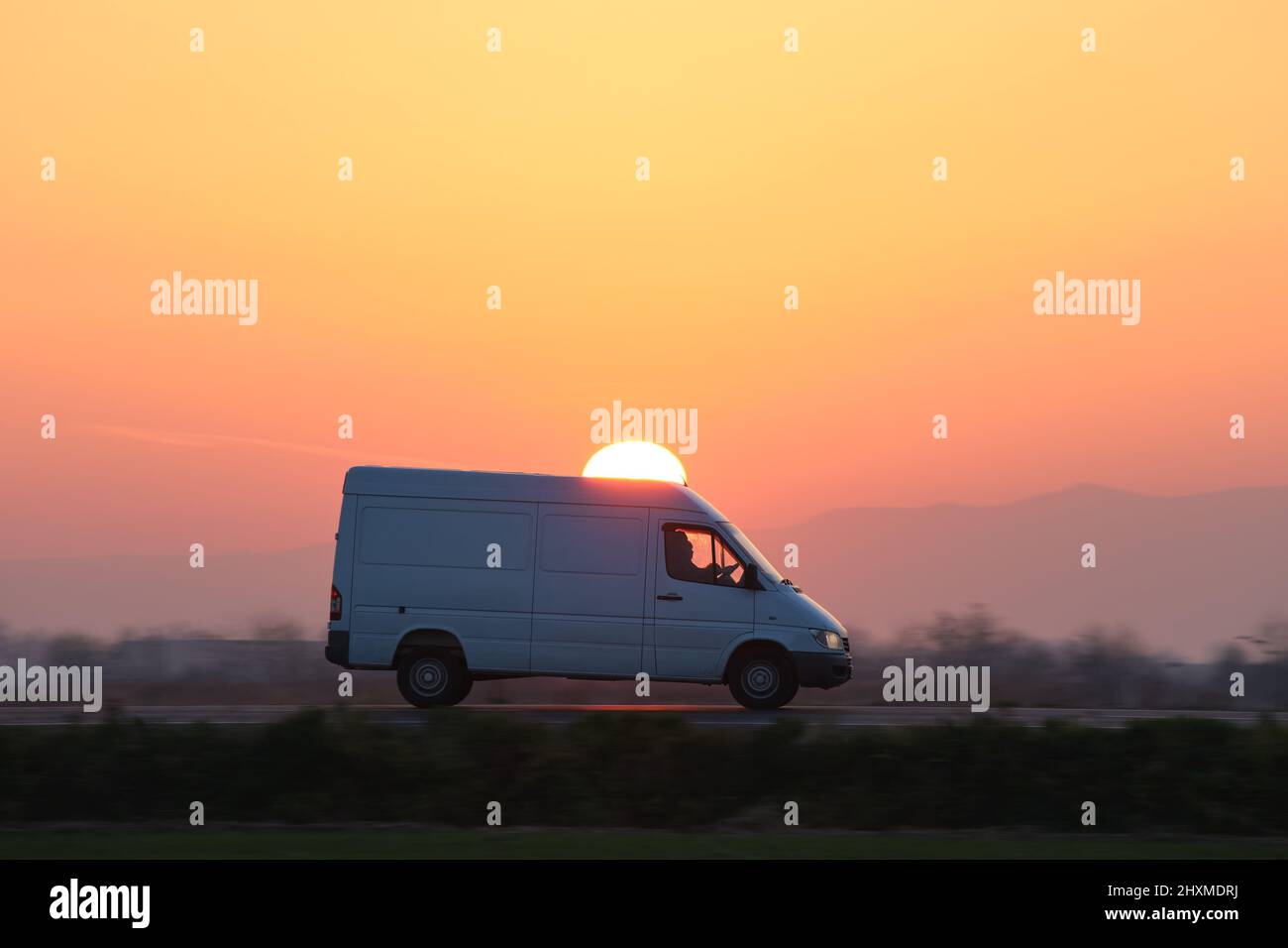 Small cargo van driving on highway hauling goods. Delivery ...