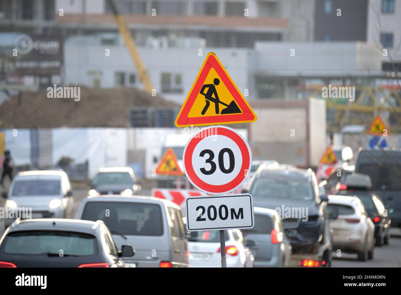 Roadworks warning traffic signs of construction work on city street and ...