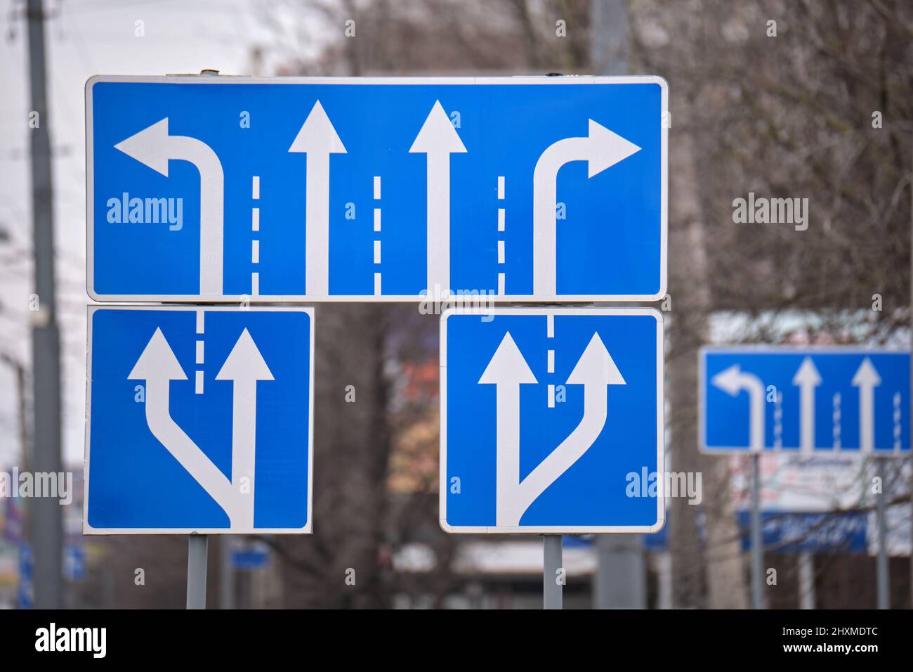 Traffic sign pointing multiple road lanes direction on city street ...