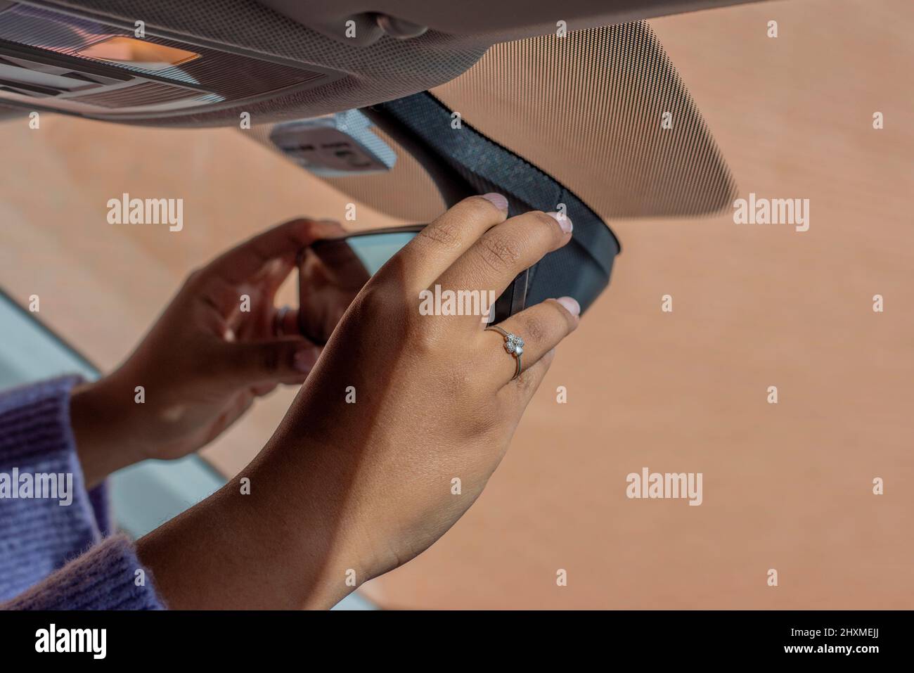 woman's hand corrects the rear-view mirror in the car Stock Photo - Alamy