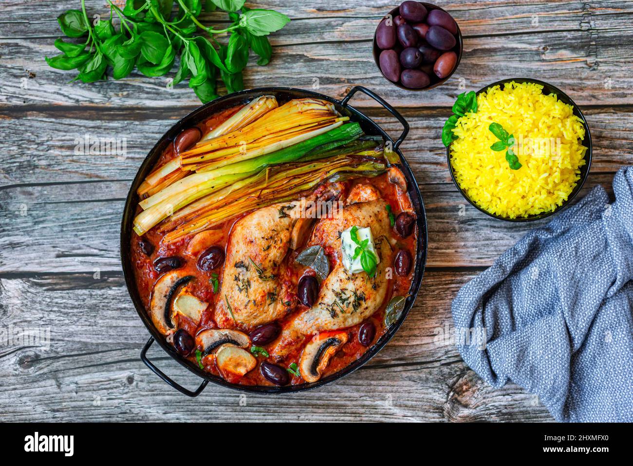 Oven roasted chicken legs with grilled leek, olives and mushroom in ...