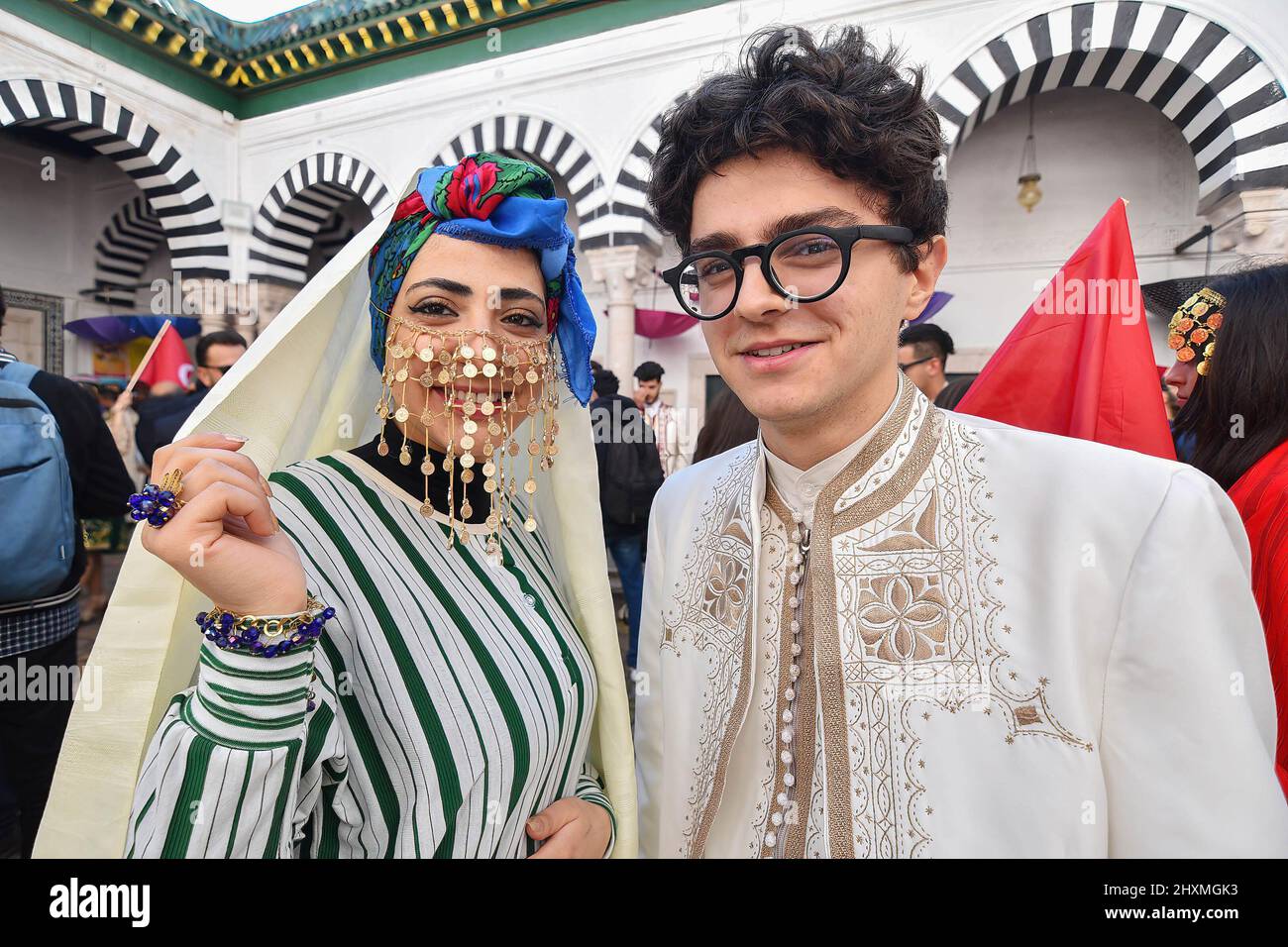 A couple wearing traditional clothing takes part in a march during the ...