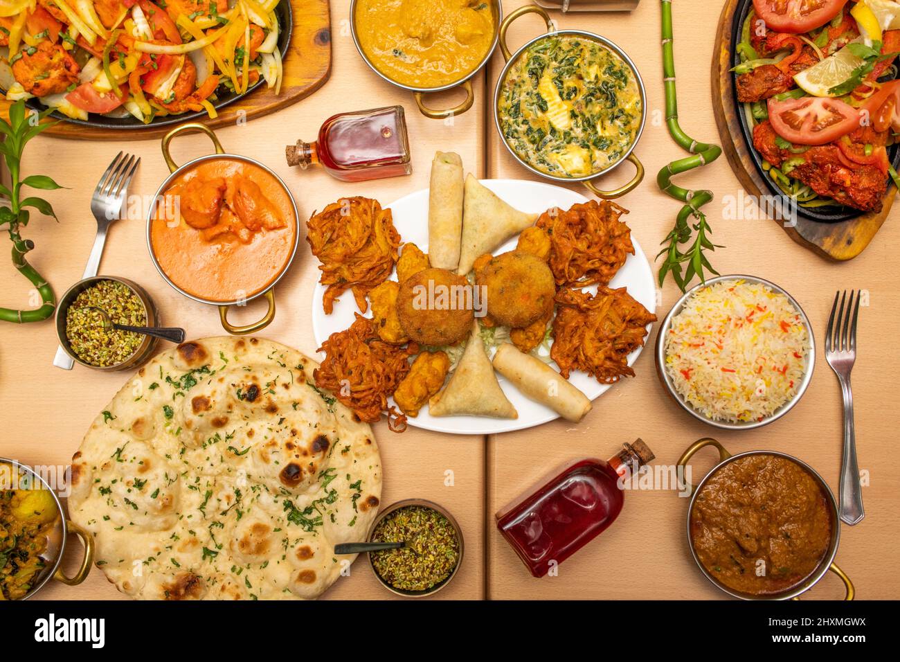 Indian food dishes, with fried chicken tikka masala, garlic naan ...