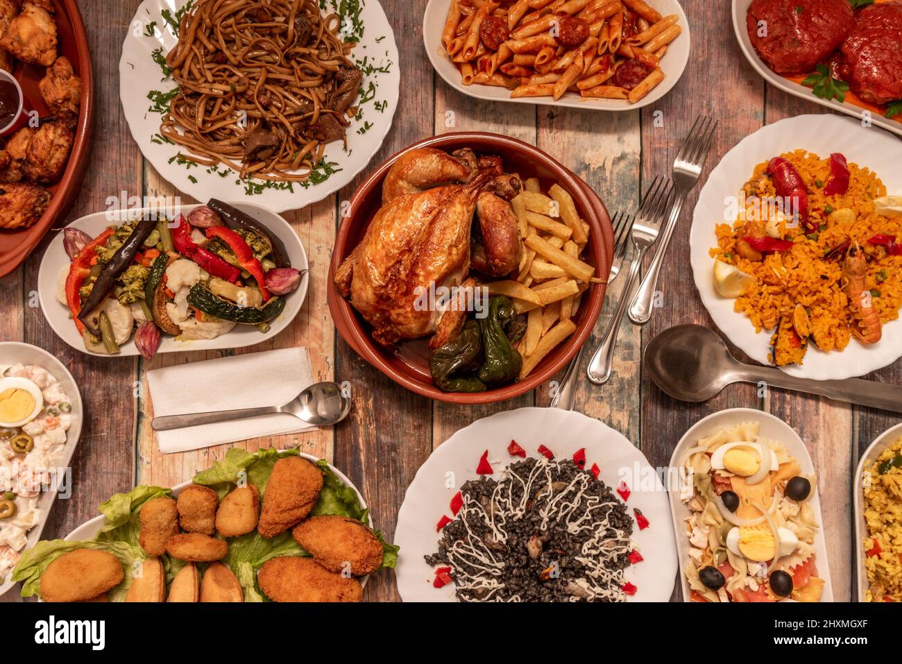 Set of assorted spanish food dishes and roasted chicken in clay pot ...
