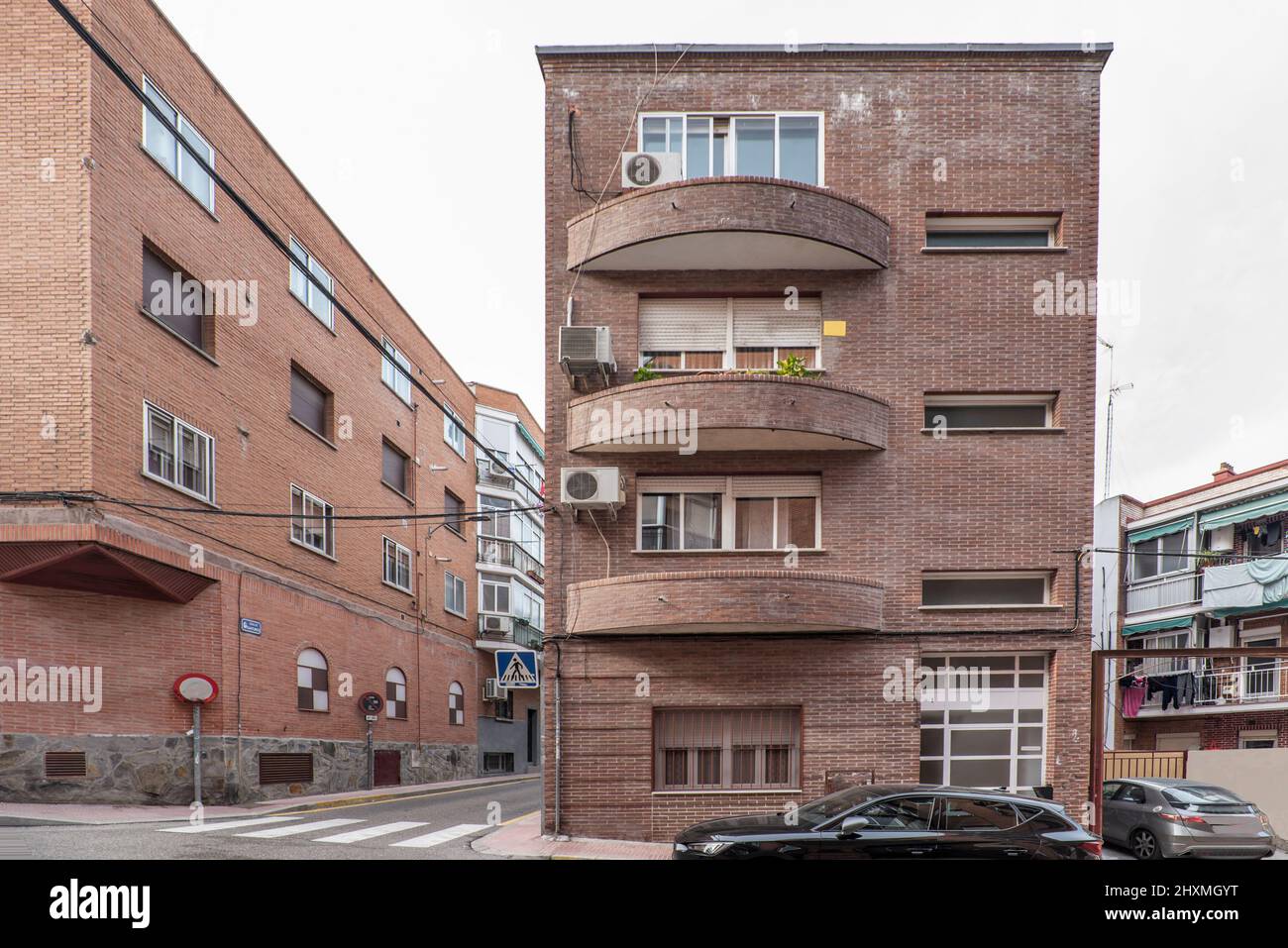 Facade of a three-story residential building with brown brick seen on a ...