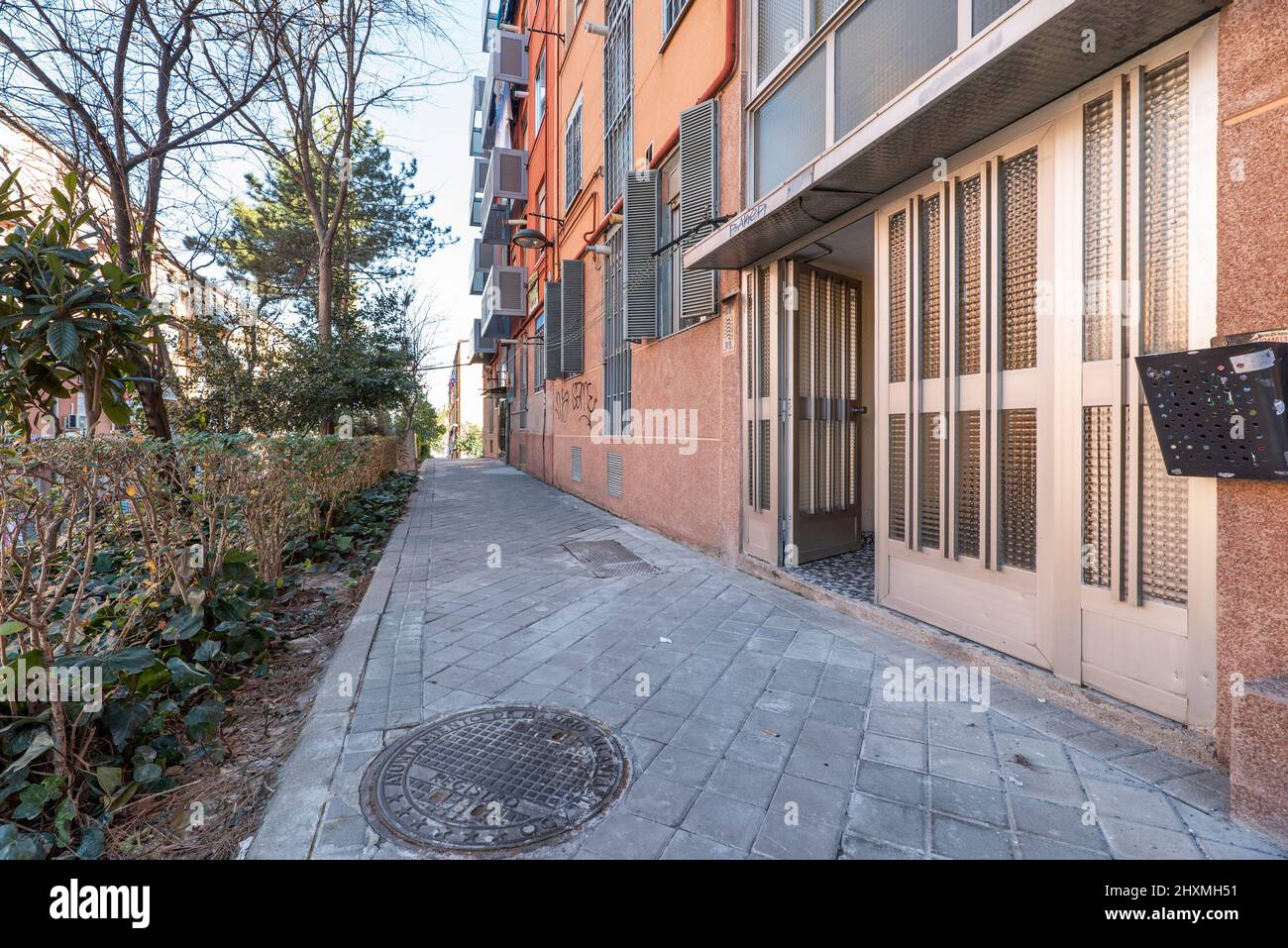 Entrance portal to a modest residential house with gardens and aluminum ...