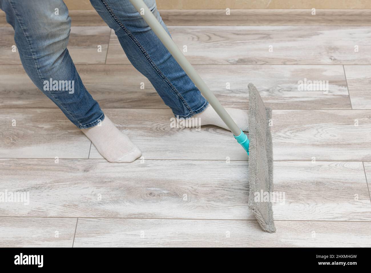 dry mop on the background of legs and laminate. High quality photo ...