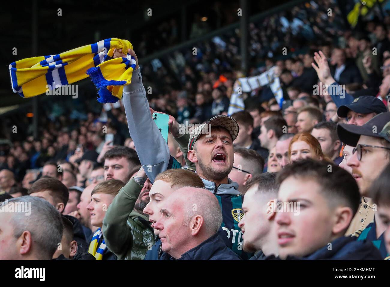Leeds, UK. 13th Mar, 2022. A Leeds United supporter waves his scarf as ...