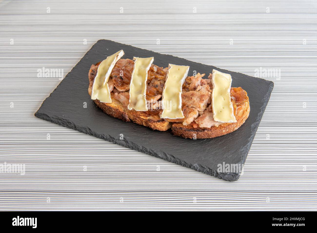 Iberian secret toast with tomato jam and Manchego cheese with crispy ...