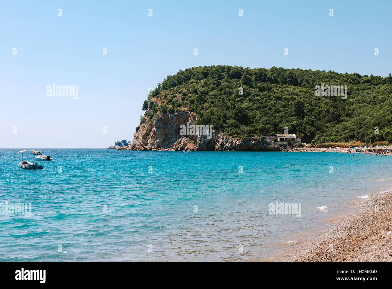Picturesque view on rocks on a sunny day from the sea. Budva riviera ...