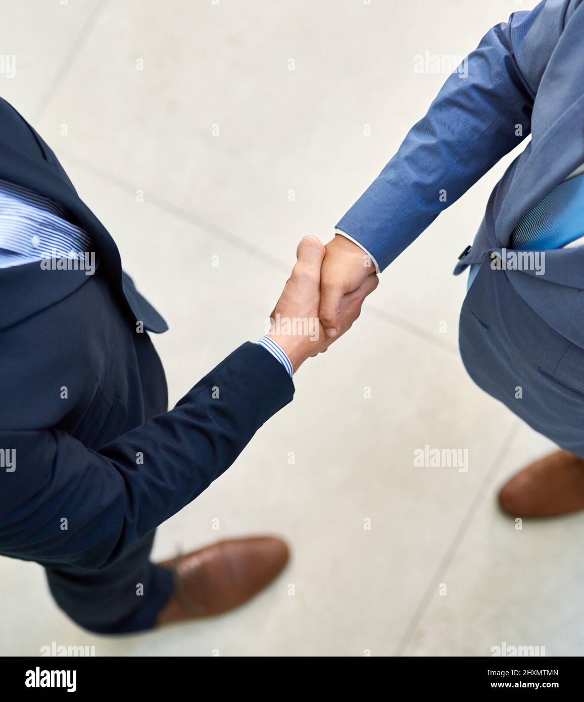 Connecting with his client. Cropped shot of two businessmen shaking ...